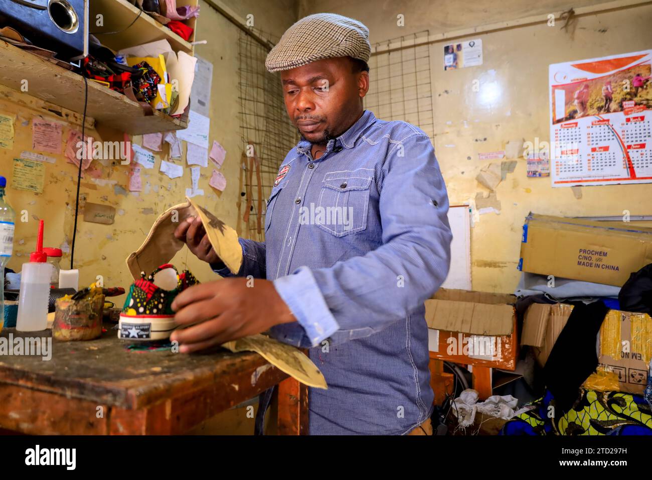 George Otieno a shoe maker from Kibera makes shoes using fabrics from ...
