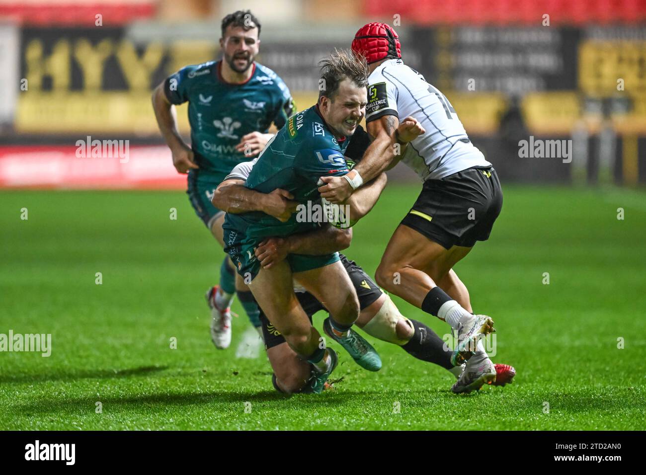 Ioan Lloyd of Scarlets is tackled by Beka Mamrikashvili of Black Lion ...