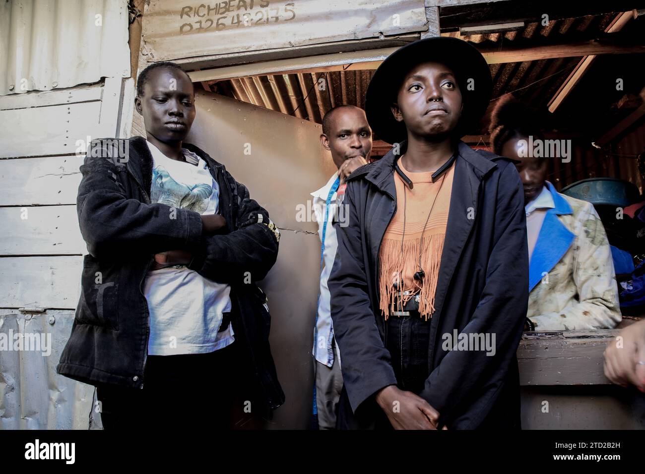 Models are posed for a photo outside Richard Onyango's stall dressed in ...