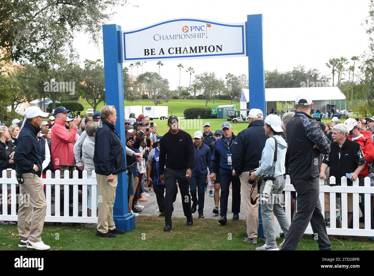 Tiger Woods and his son, Charlie Woods, arrive at the first hole to ...