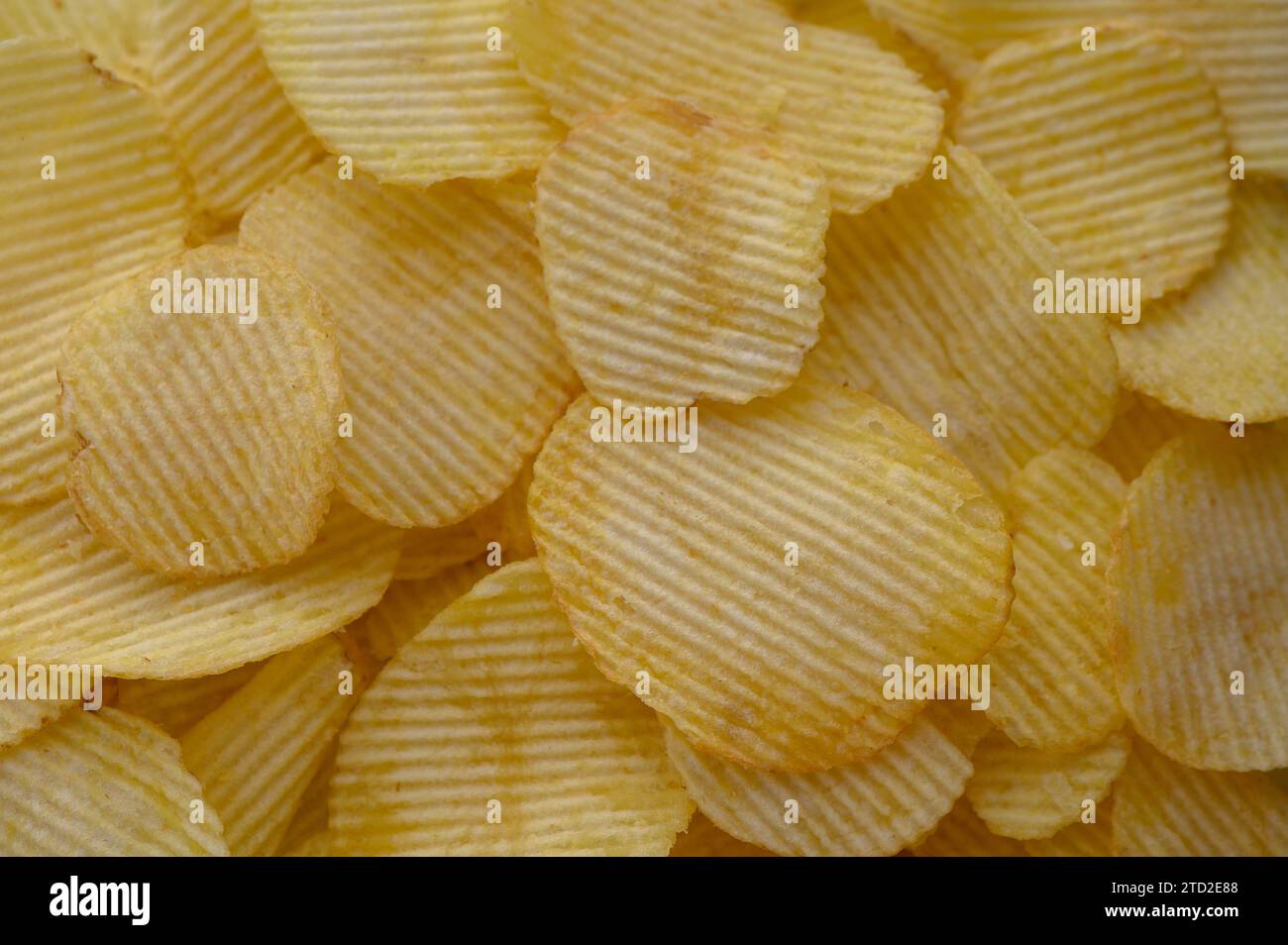 food background from delicious chips poured out of a pack 4 Stock Photo ...