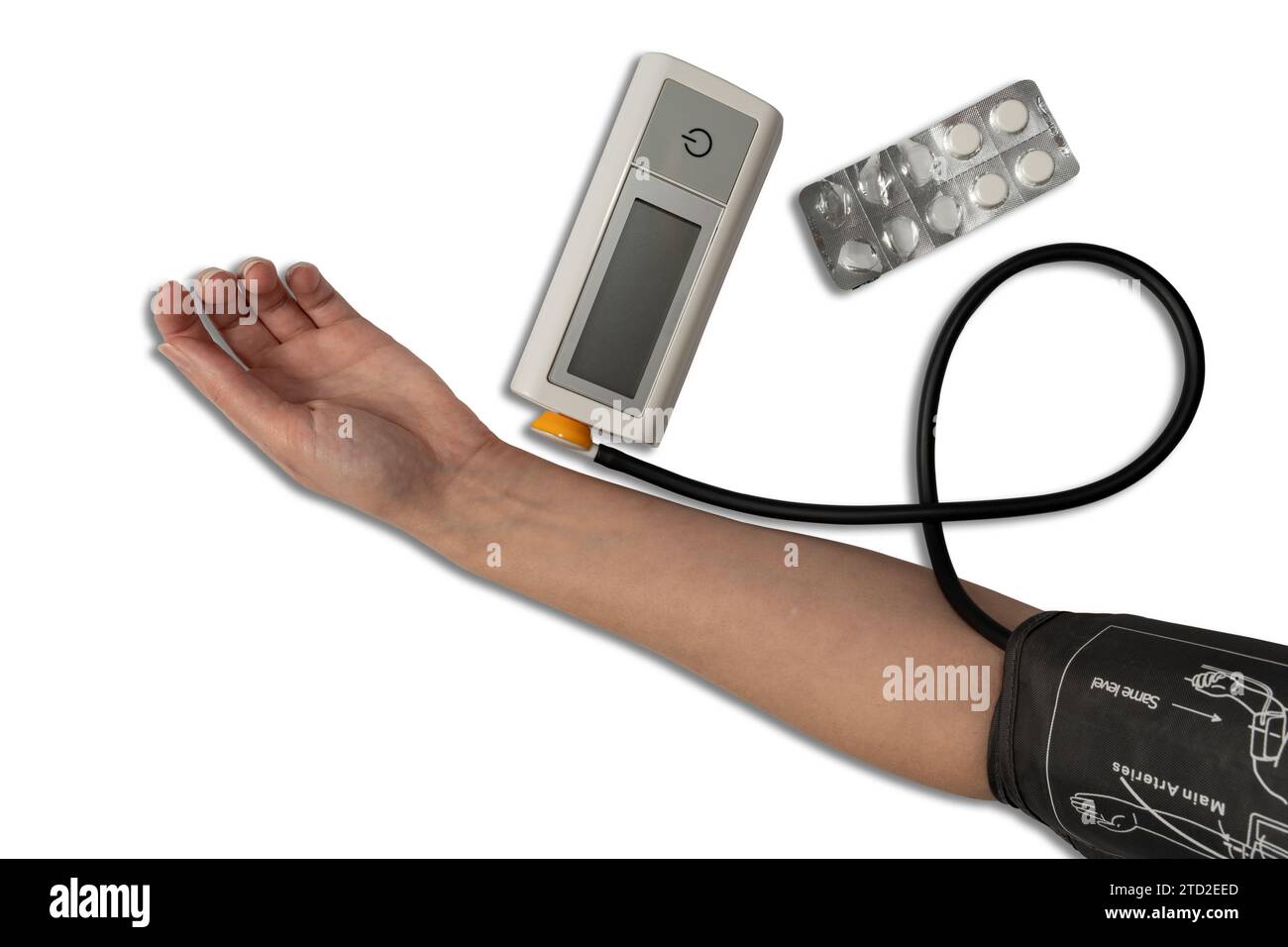 Digital blood pressure monitor and pack of pills on white background ...