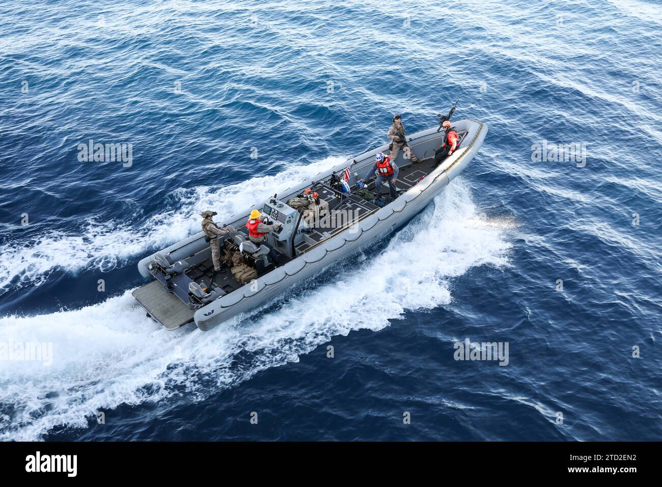 Sailors assigned to the amphibious dock landing ship USS Harpers Ferry ...