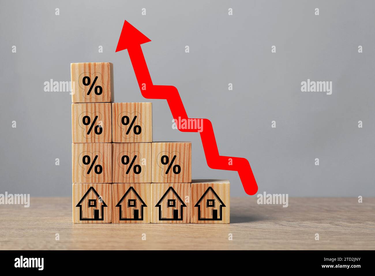 Mortgage rate rising illustrated by upward arrow over cubes with ...