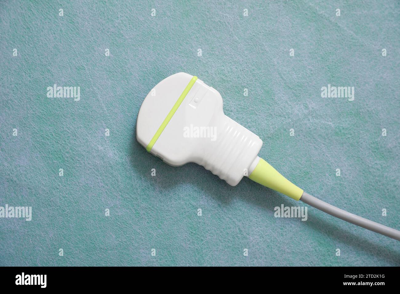 Ultrasonic transducer on green examination table, top view. Ultrasound ...