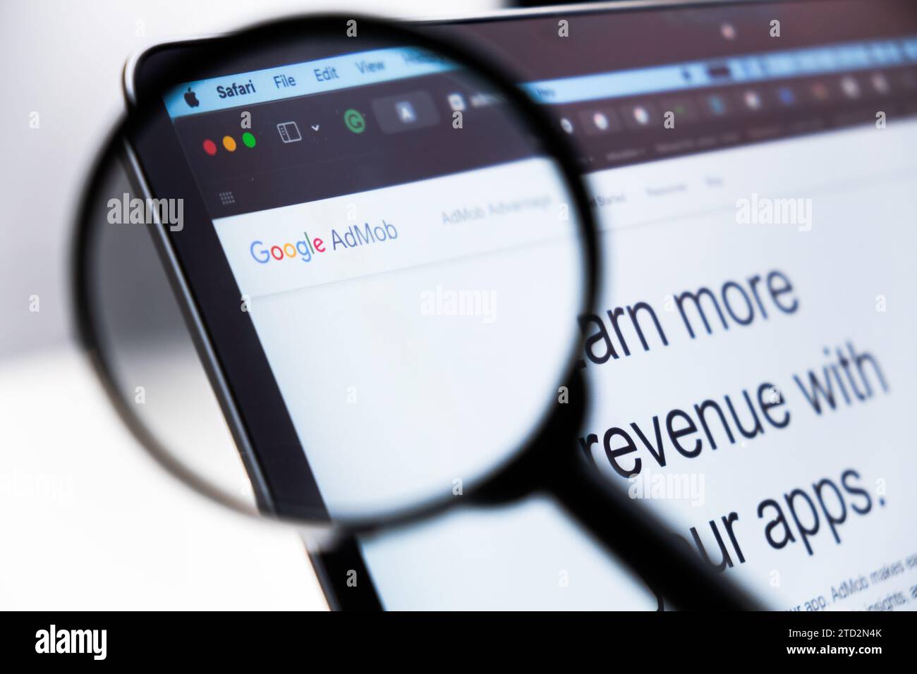 Google AdMob logo enlarged through a magnifying glass on a laptop ...