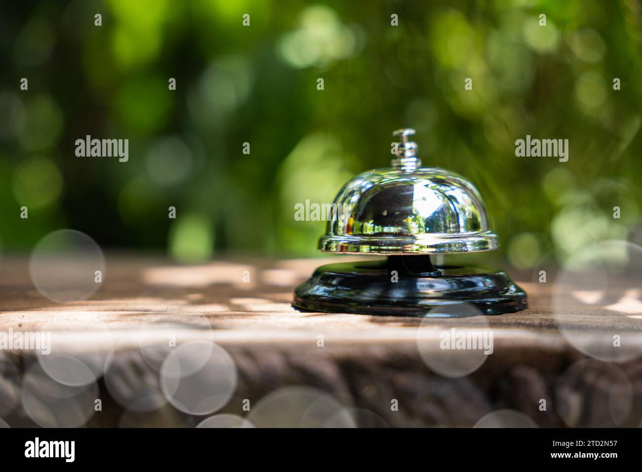 Closeup of silver service restaurant bell on wooden counter desk Stock ...
