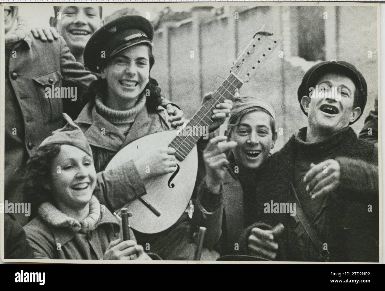 November 1936. Spanish Civil War. Militiawoman playing a lute. Moment ...