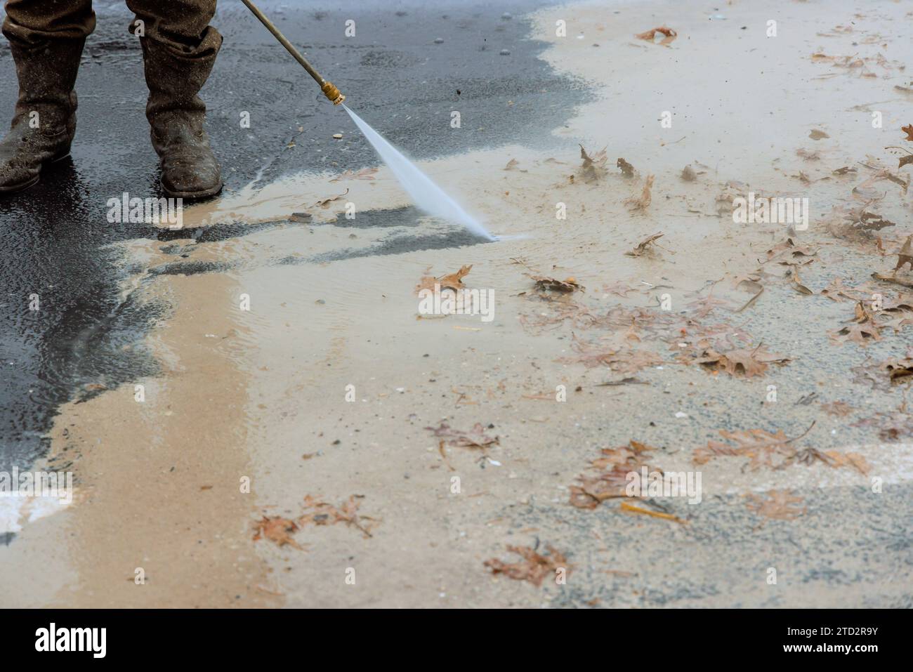 Street sprayed clean with pressurized water, wet washing cleaning of ...