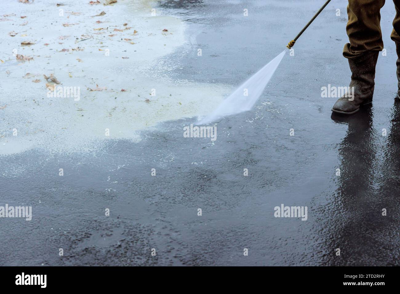 Pressurized water is used to clean streets with wet scrubbing Stock ...