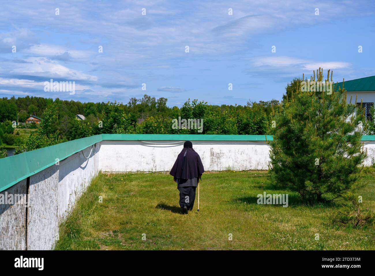 An elderly nun in the garden of the Alexander Svir Monastery in Karelia ...