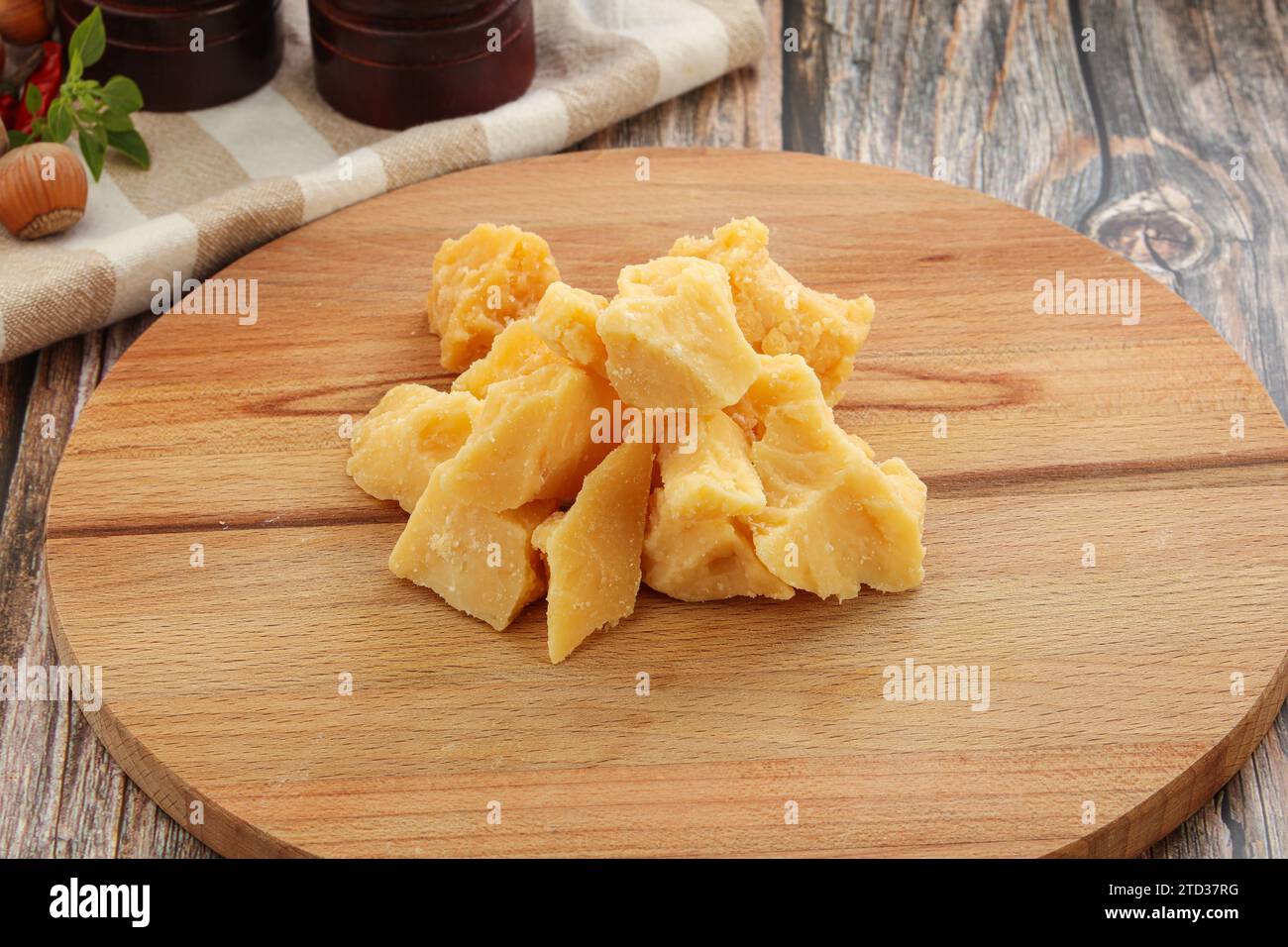 Crushed hard parmesan cheese pieces over board Stock Photo - Alamy