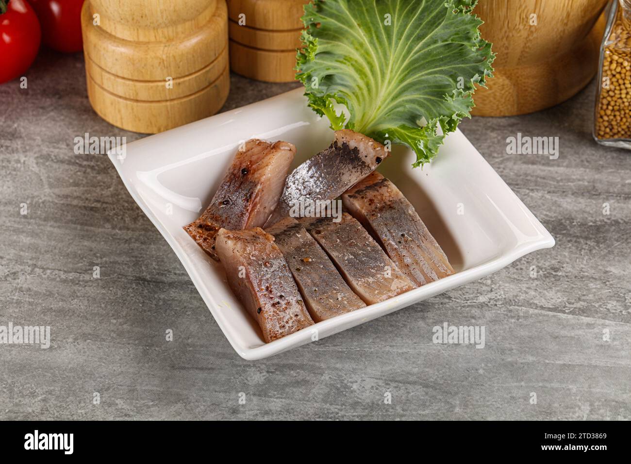 Sliced spicy salted herring fillet snack Stock Photo - Alamy