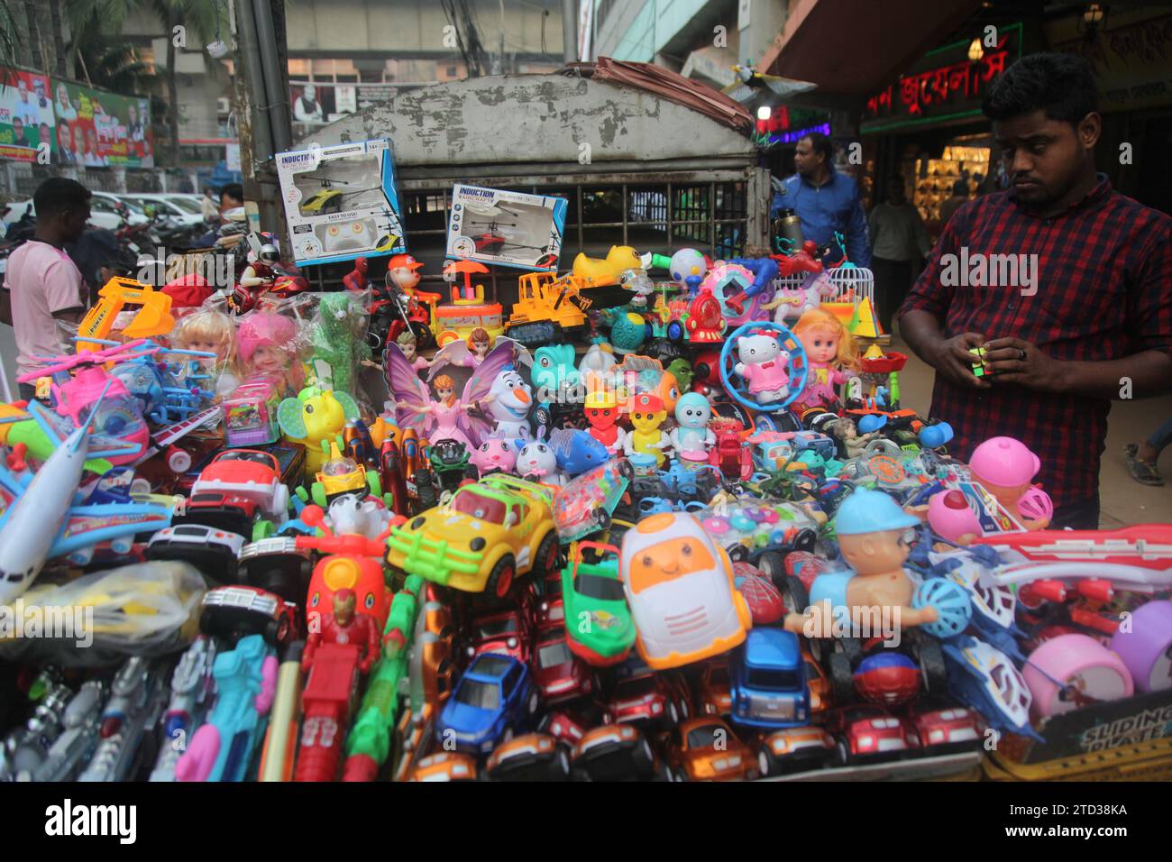 Dhaka Bangladesh 01, January 2000, street vendor selling colorful plastic toys by the roadside ...