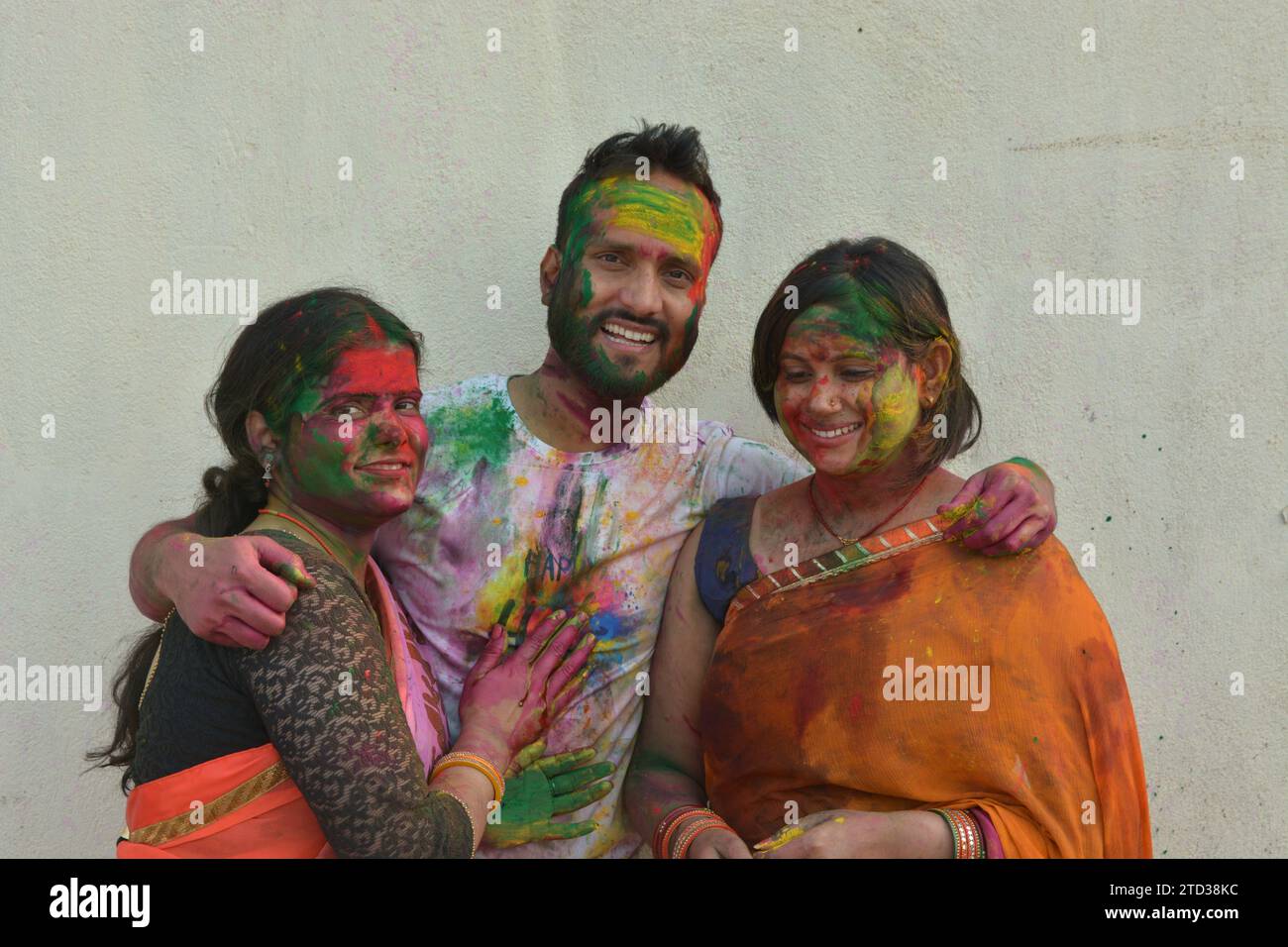 Portrait of a young Indian boy and girl playing holi. Happy couple ...