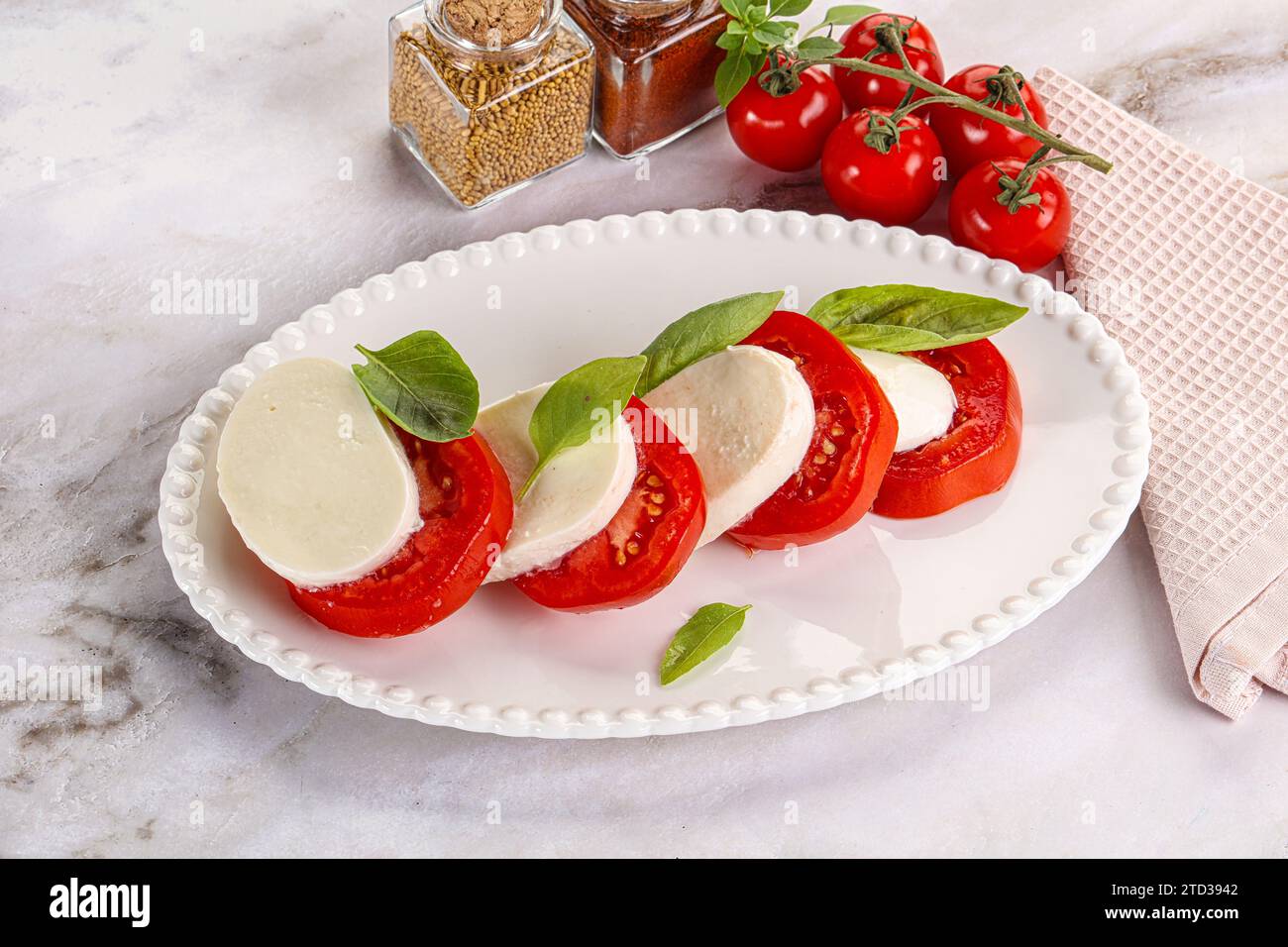 Italian caprese salad with mozzarella, tomato and basil Stock Photo - Alamy