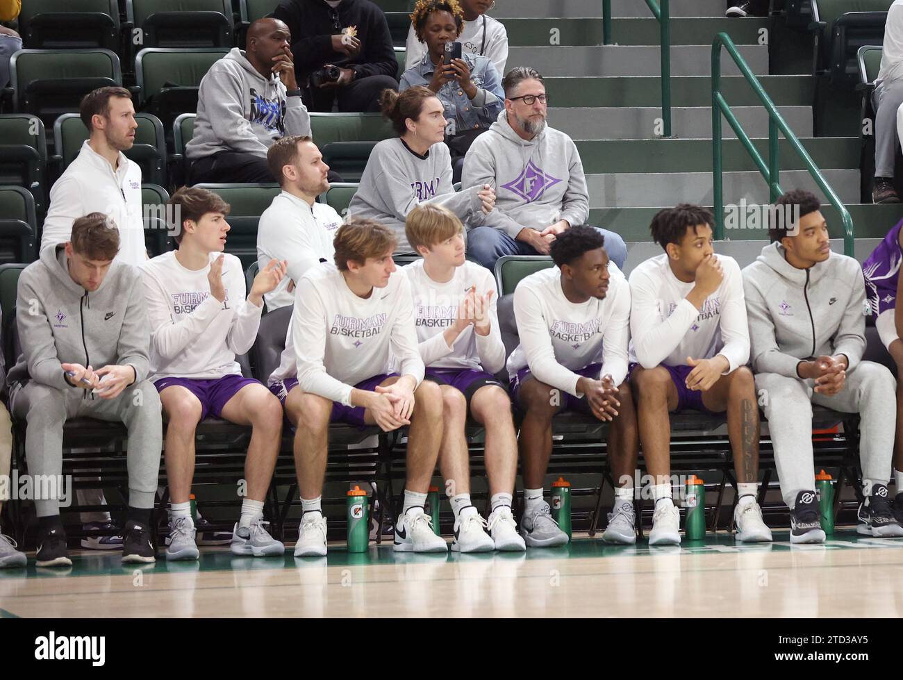 The Furman Paladins bench cheer their team on during a men’s basketball ...