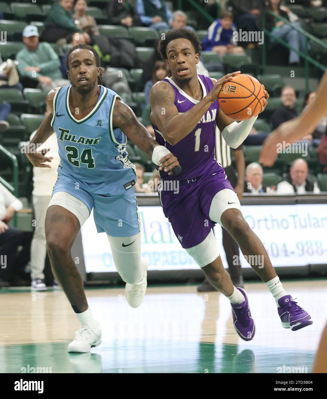 Furman Paladins guard JP Pegues (1) tries to drive past Tulane Green ...