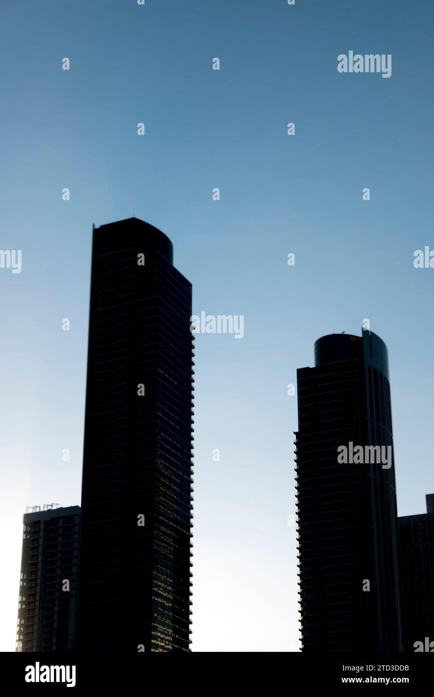Silhouettes of modern high-rise office building in downtown city with ...