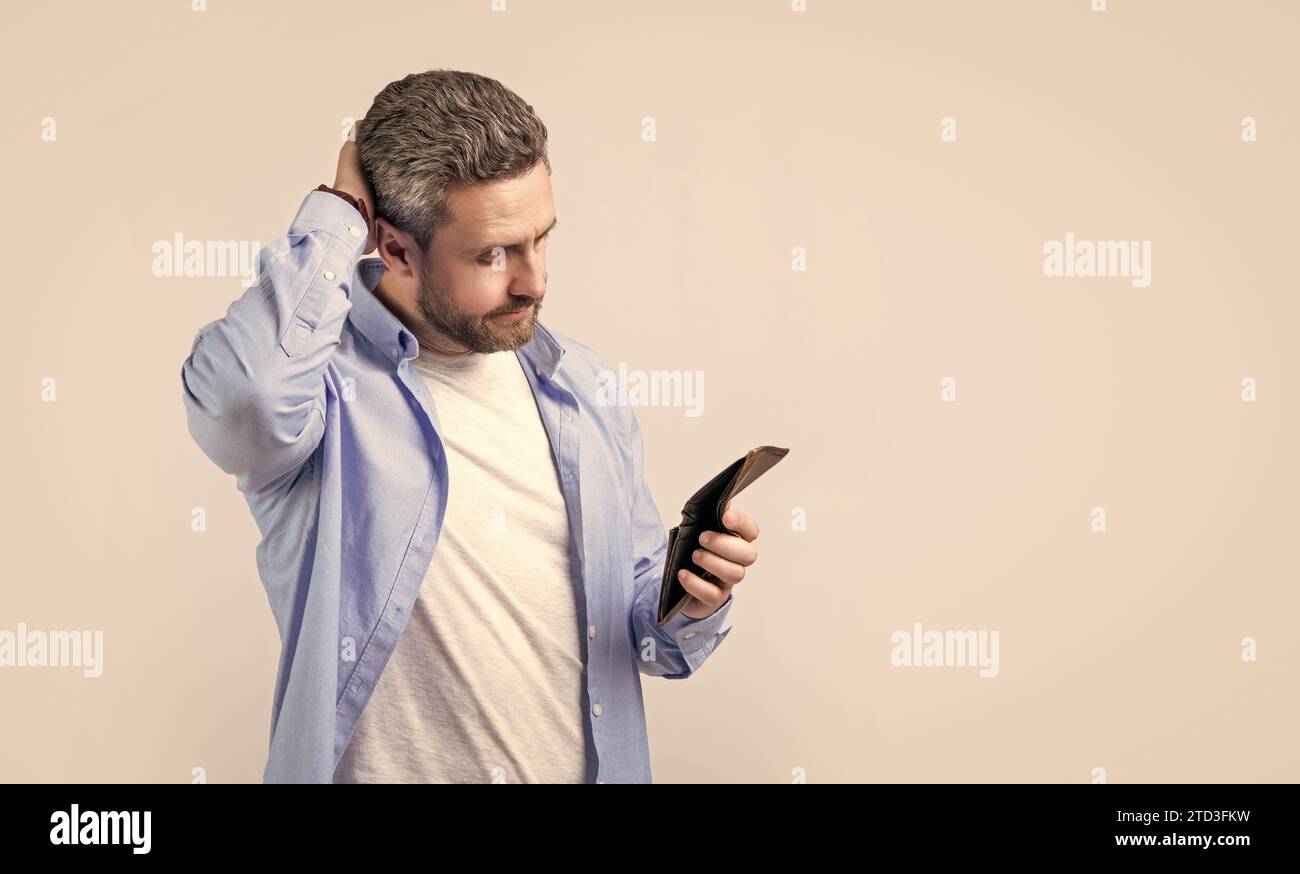 confused bankrupt man with wallet at hand. photo of bankrupt man with ...