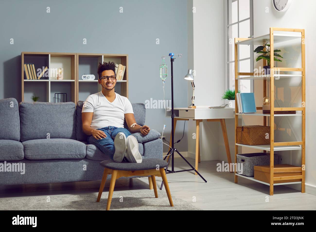 Happy, relaxed man receiving an intravenous vitamin infusion through an ...