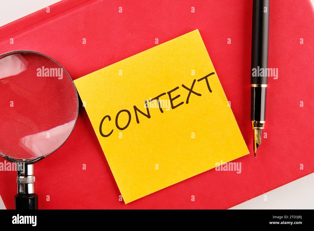 CONTEXT the inscription on the sticker lying on a red notebook next to ...