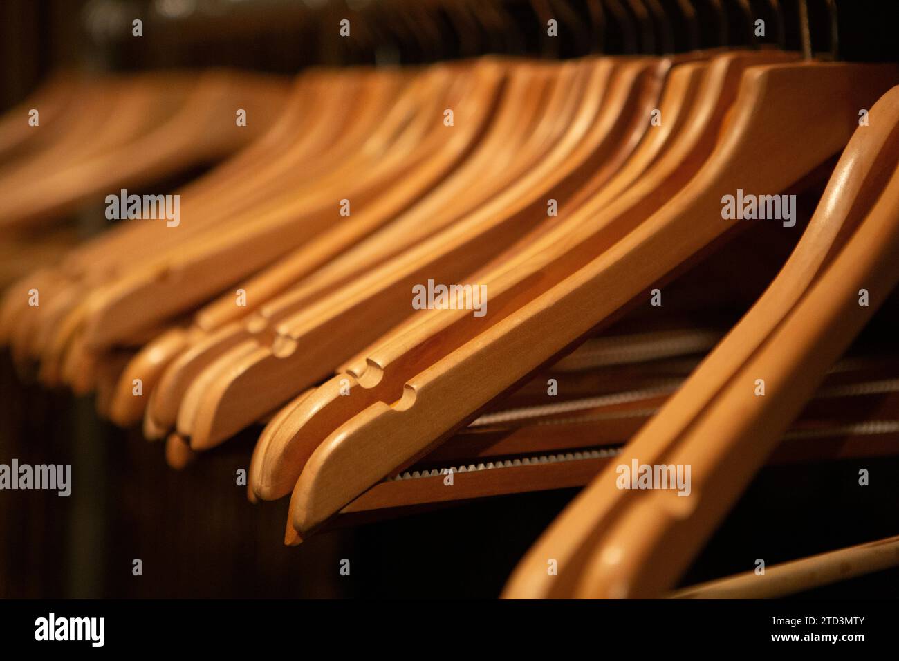 A row of hangers without clothes in a concert hall Stock Photo - Alamy