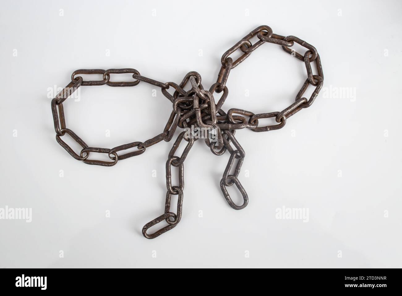 Knot and bow made with rusty steel chain on white Stock Photo - Alamy