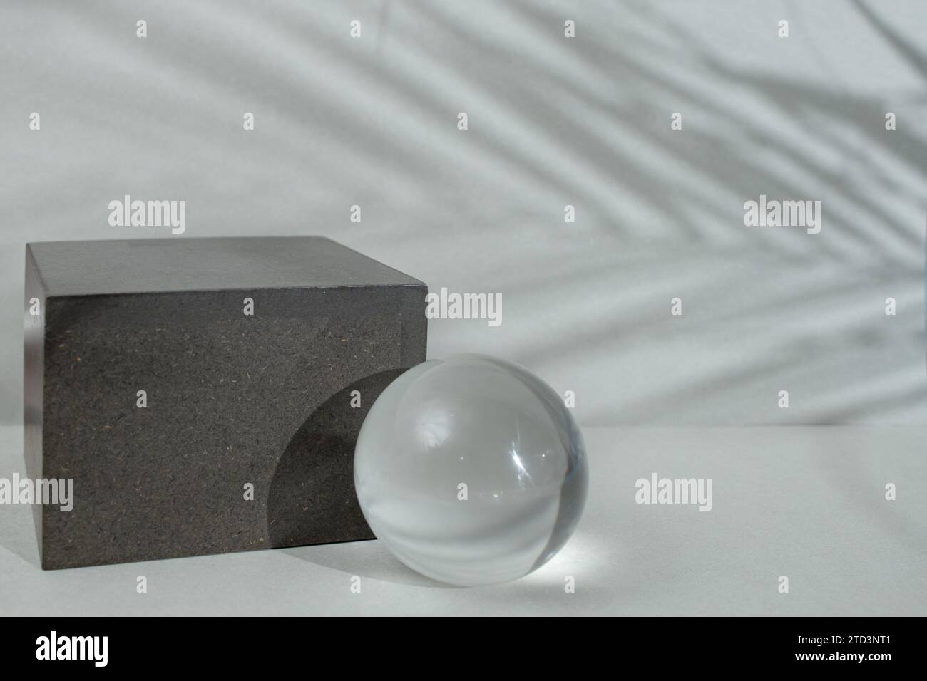 Empty gray backdrop with a cube and a glass sphere on a gray background ...