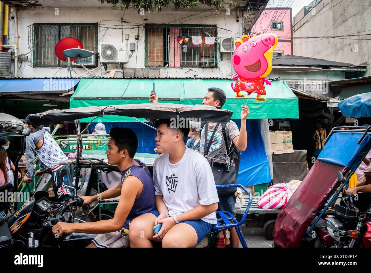 A Tuk Tuk Or Trike Driver And His Passenger Make Their Way Through The Busy Streets Of The