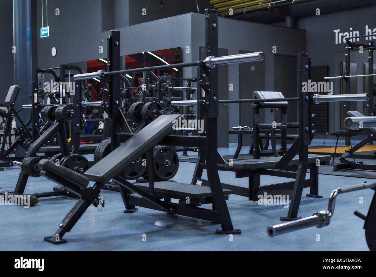 Modern gym. Sports equipment in the gym. Barbells of different weights ...