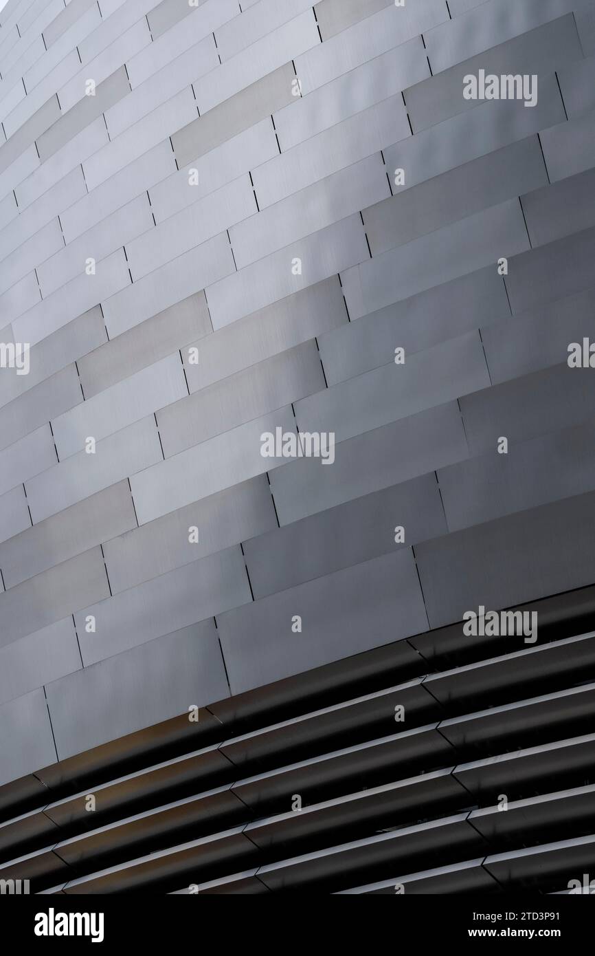 Abstract mosaic of geometric shapes adorns the modern building's facade ...