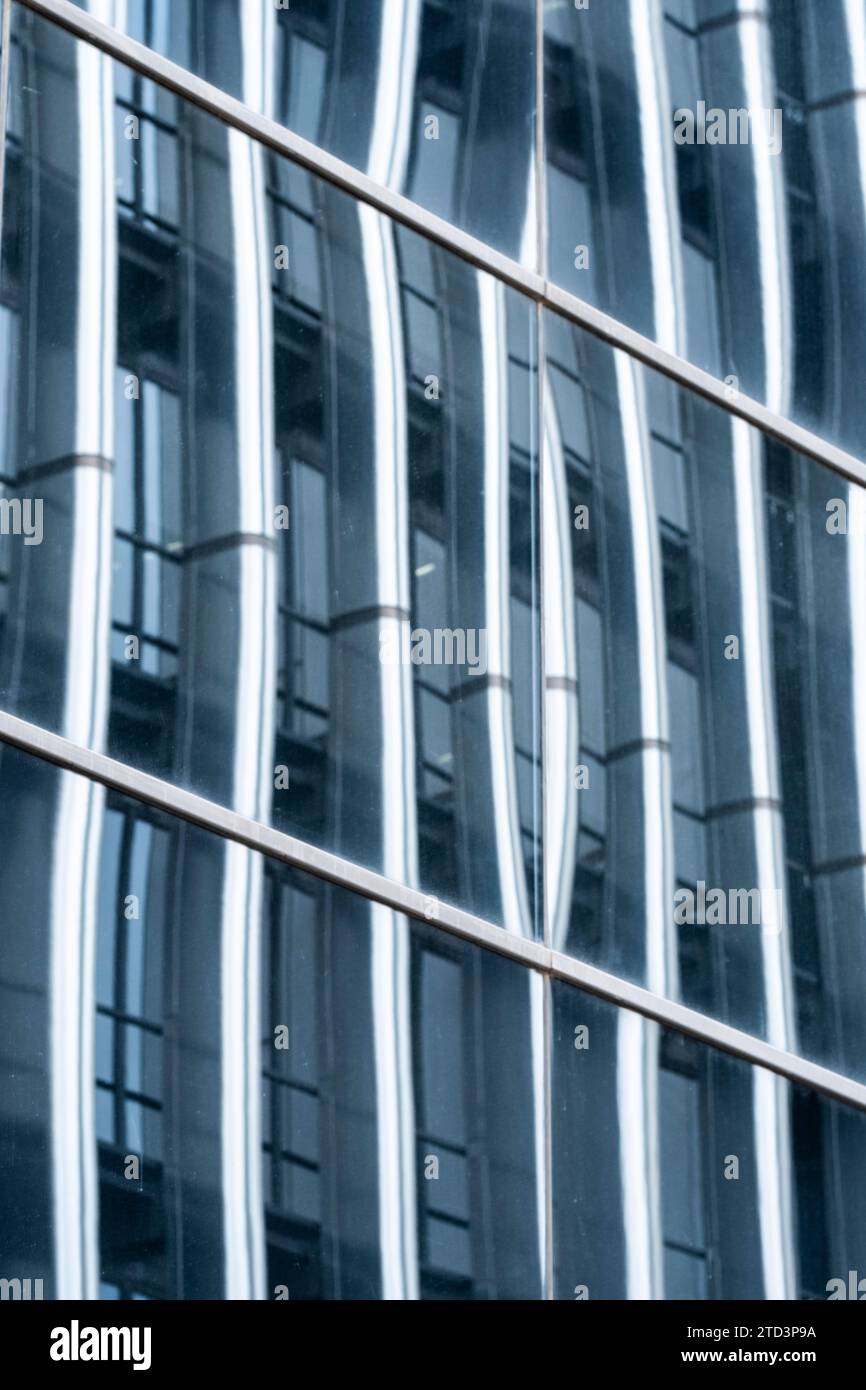 Abstract mosaic of geometric shapes adorns the modern building's facade ...