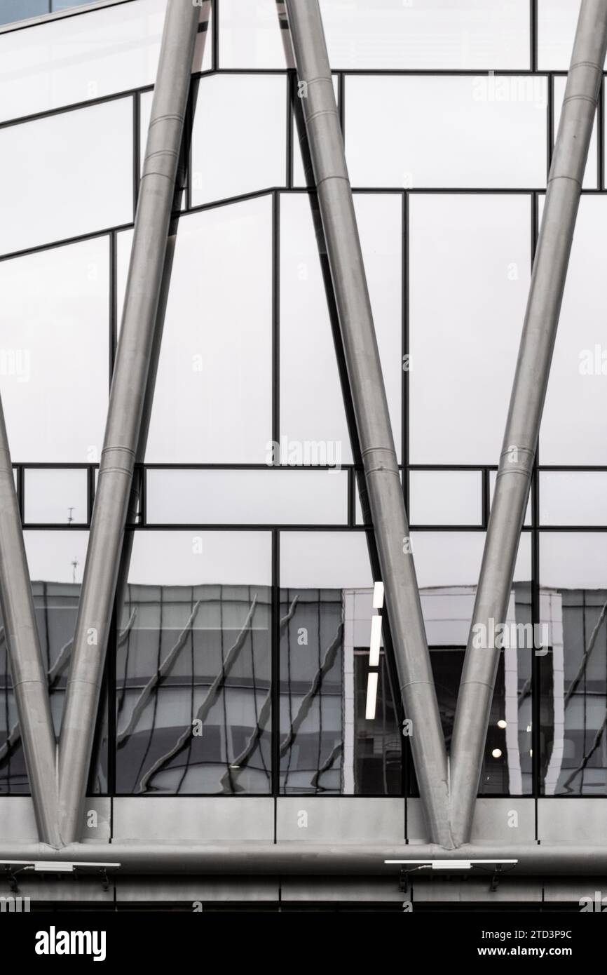 Abstract mosaic of geometric shapes adorns the modern building's facade ...