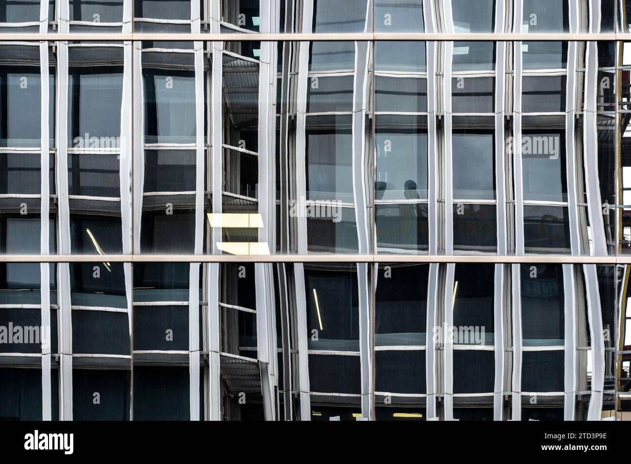 Abstract mosaic of geometric shapes adorns the modern building's facade ...