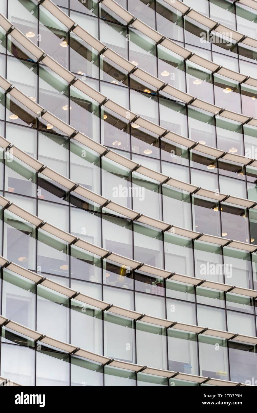 Abstract mosaic of geometric shapes adorns the modern building's facade ...