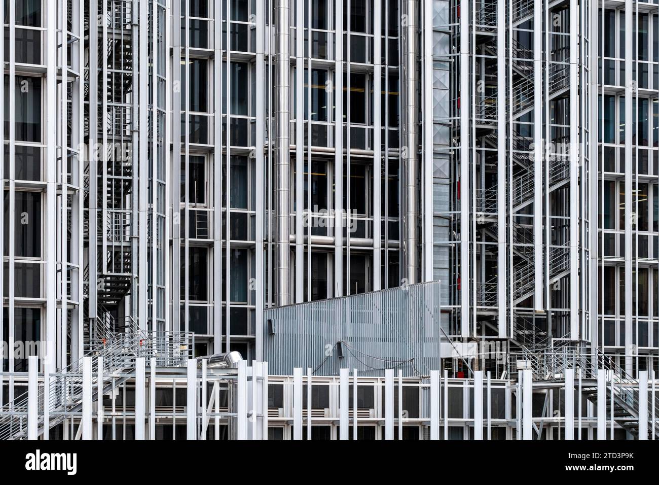 Abstract mosaic of geometric shapes adorns the modern building's facade ...