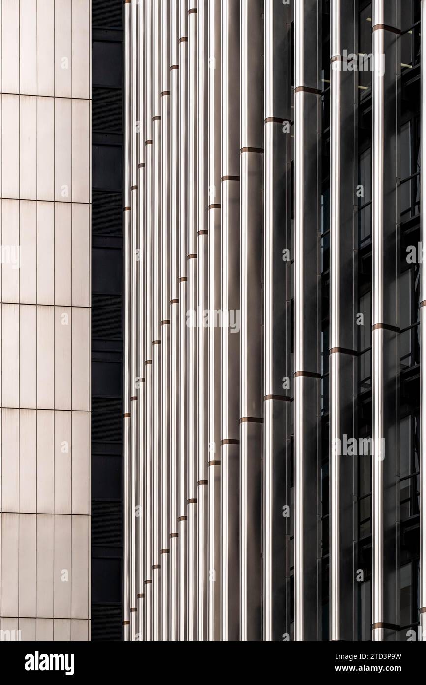 Abstract mosaic of geometric shapes adorns the modern building's facade ...