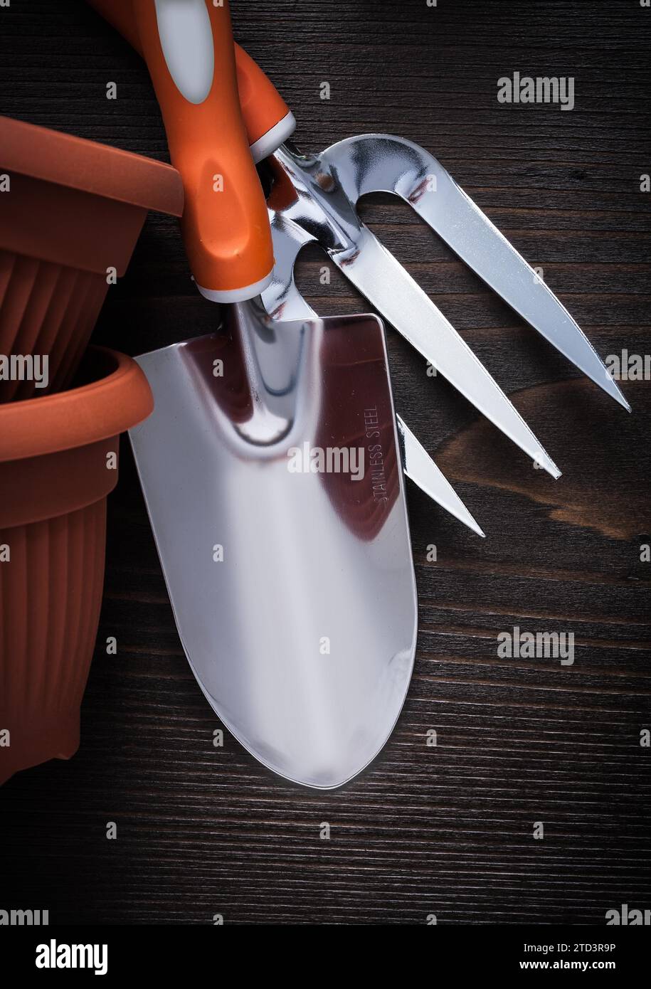 Clay planting pots trowel fork and hand spade on vintage wood board ...