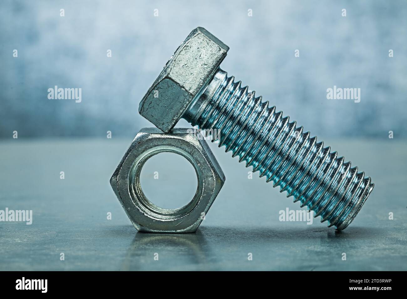 Bolt on nut metalic background close up Stock Photo - Alamy