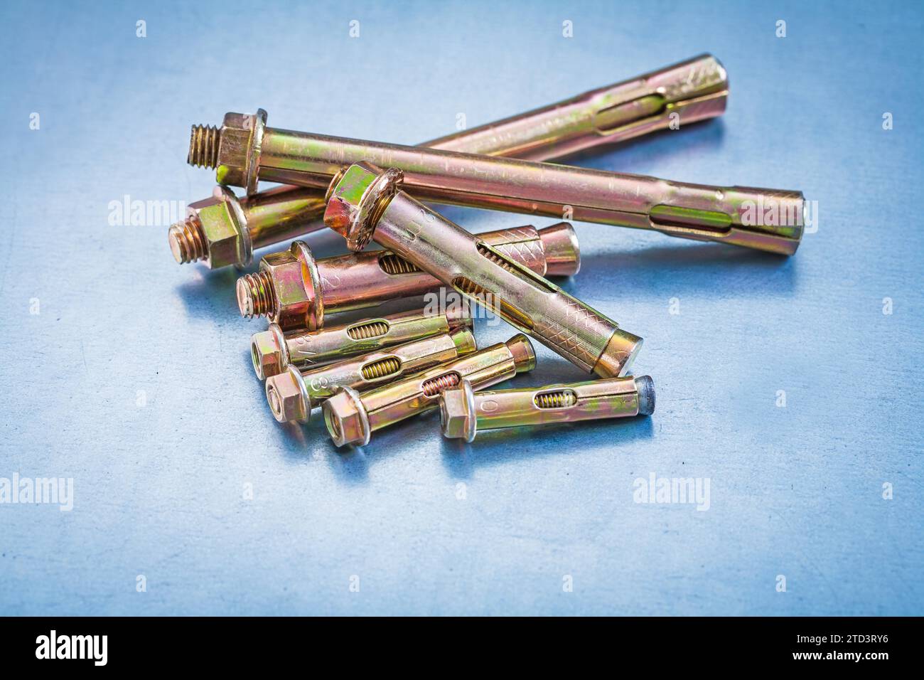 Group of metal anchor bolts with construction nuts on metallic ...