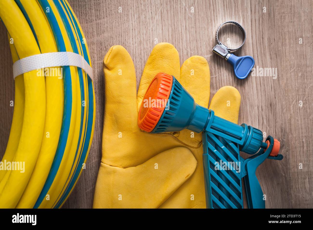 Hand spraying rubber hose with spray nozzle leather safety gloves and ...