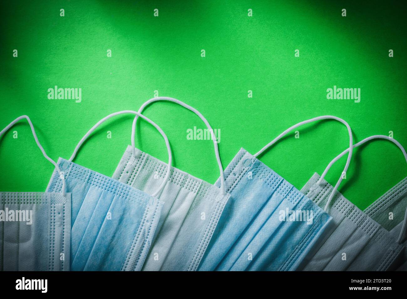 Disposable respiratory face masks on green background medicine concept ...