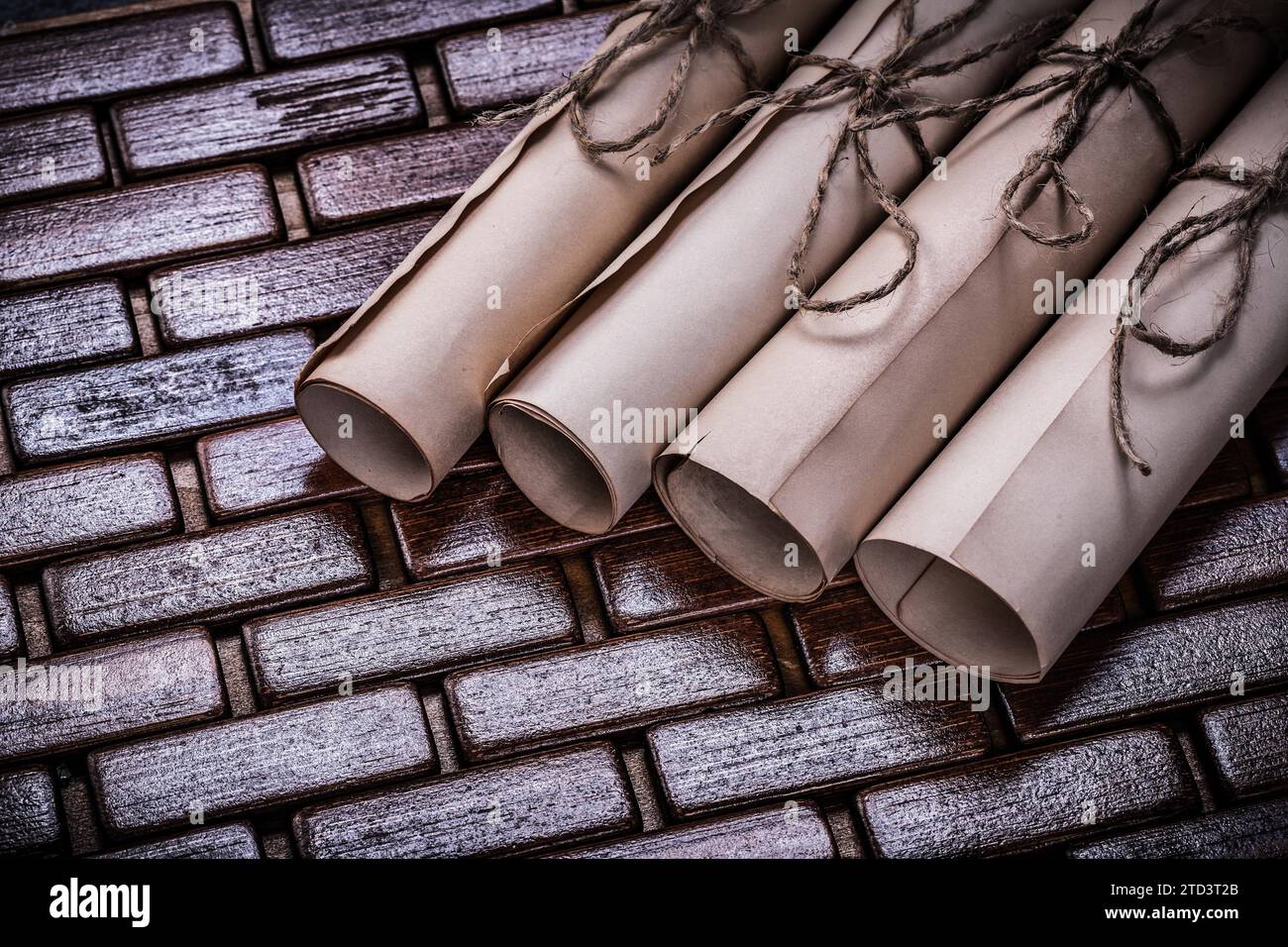 Pile of vintage parchment rolls on wicker wooden matting Stock Photo ...