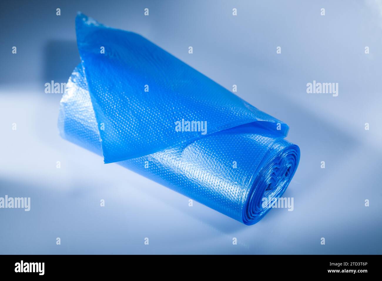 Rolled garbage bags on white background Stock Photo - Alamy