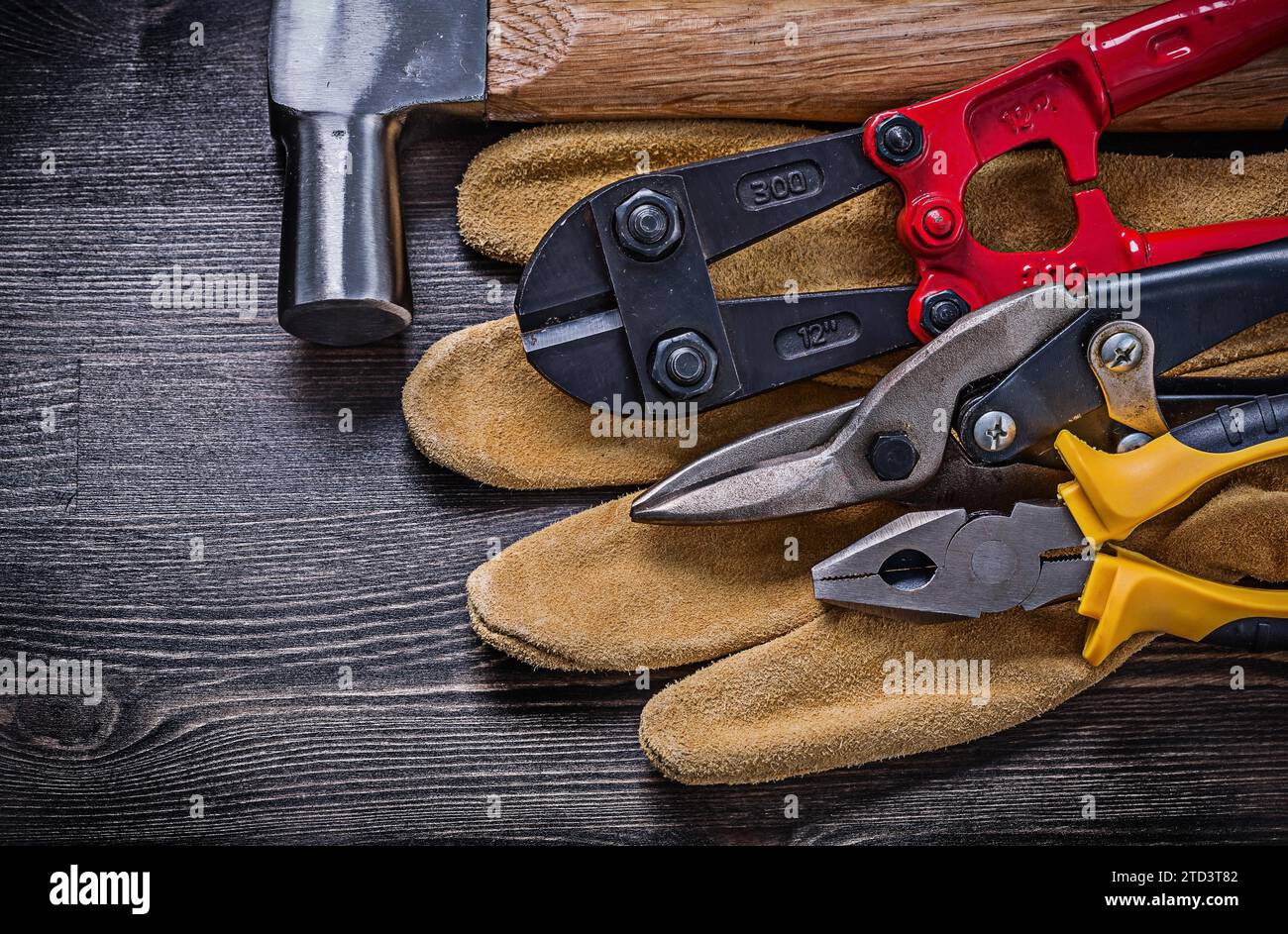 Safety gloves pliers steel cutter tin snips claw hammer Stock Photo - Alamy