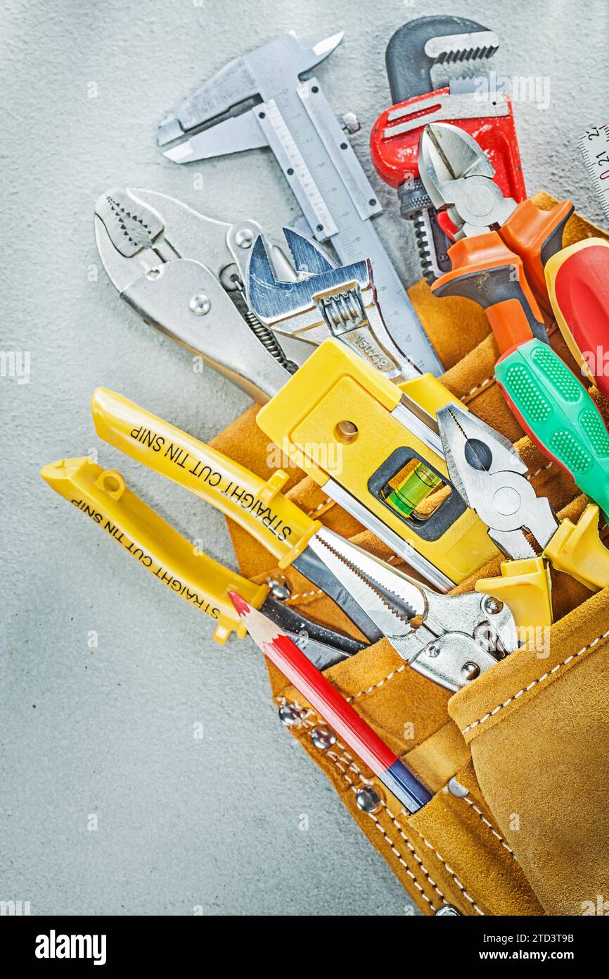 Set of construction tooling in leather tool belt Stock Photo - Alamy