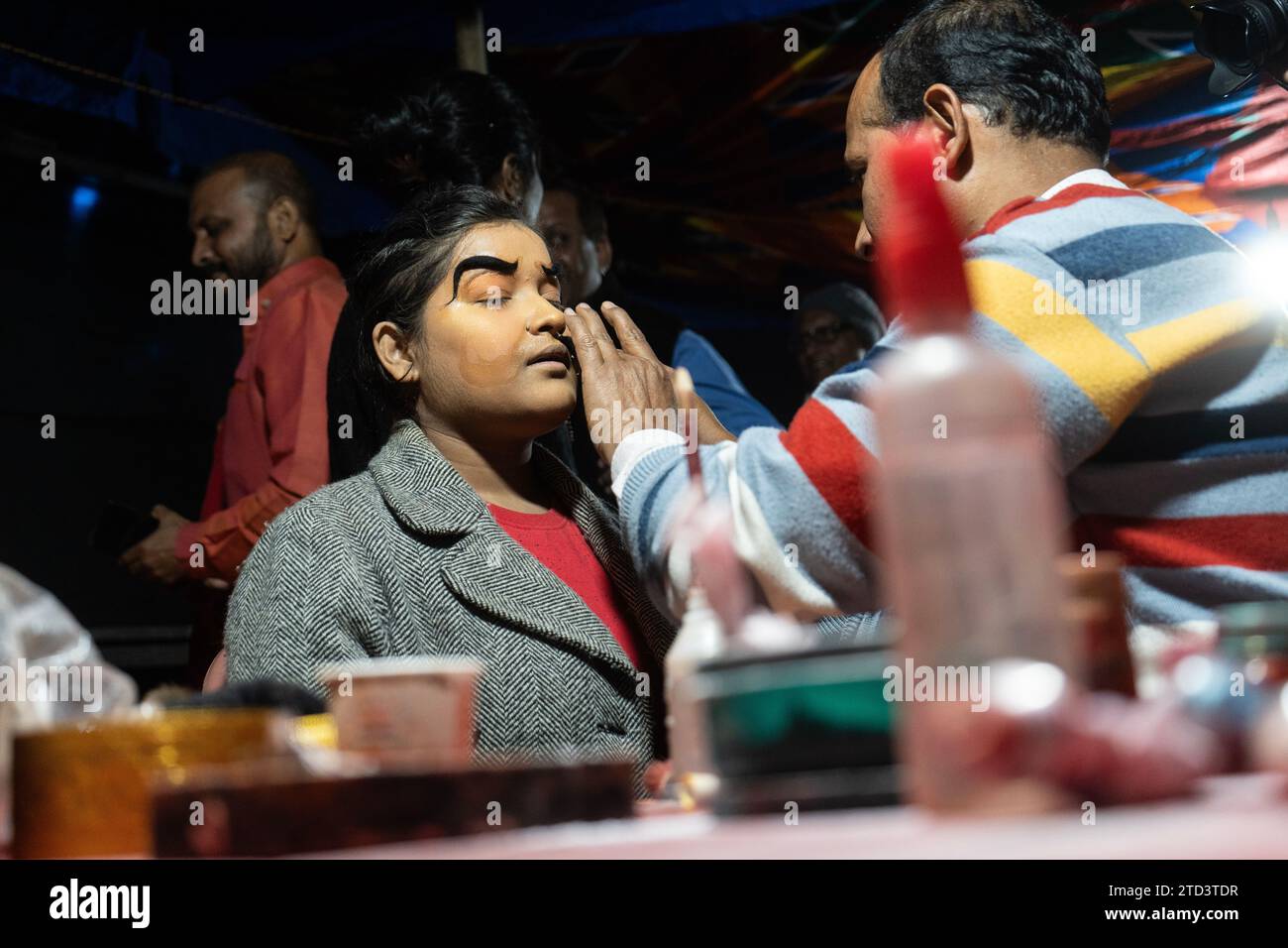 Artists gets make-up form a make-up artist backstage to perform in an ...