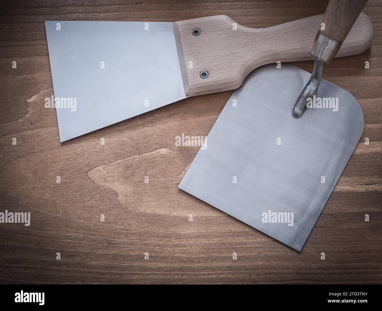 Stainless steel putty knife bricklayer trowel on wooden background ...