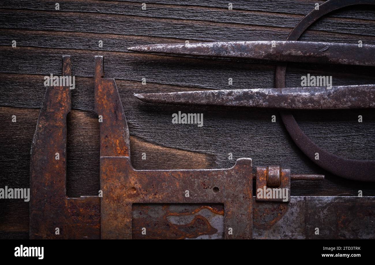 Set of rusty calipers on vintage wooden background Stock Photo - Alamy